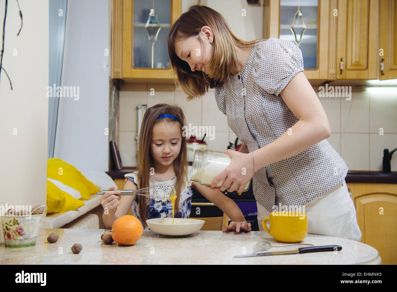 Small girl going to beat the dough for pancakes Stock Photo - Alamy