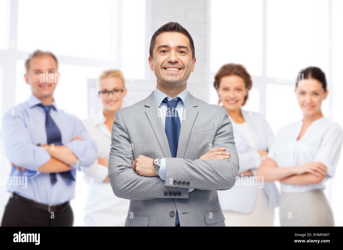 happy smiling business team over office room Stock Photo - Alamy