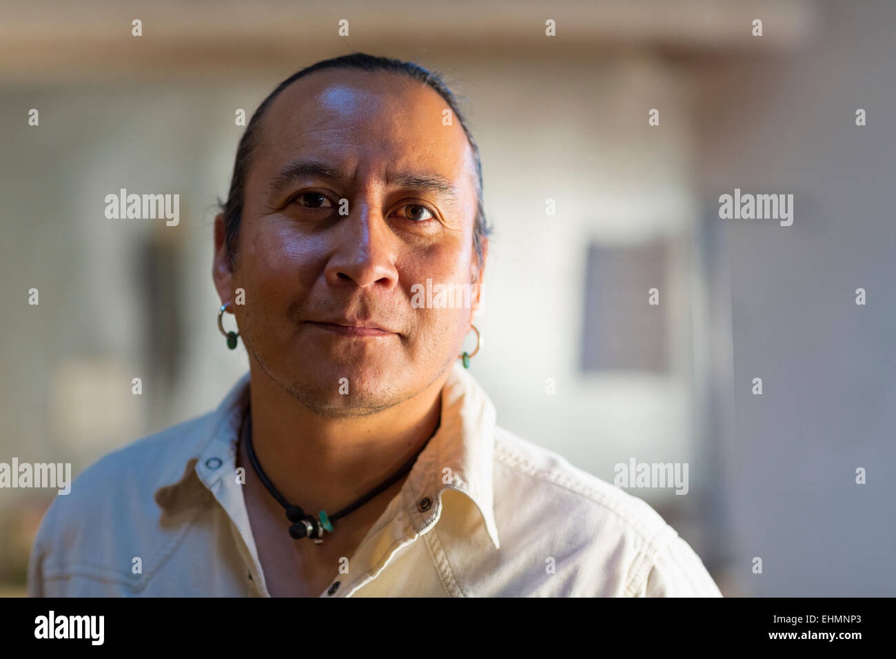 Native American man smiling indoors Stock Photo - Alamy