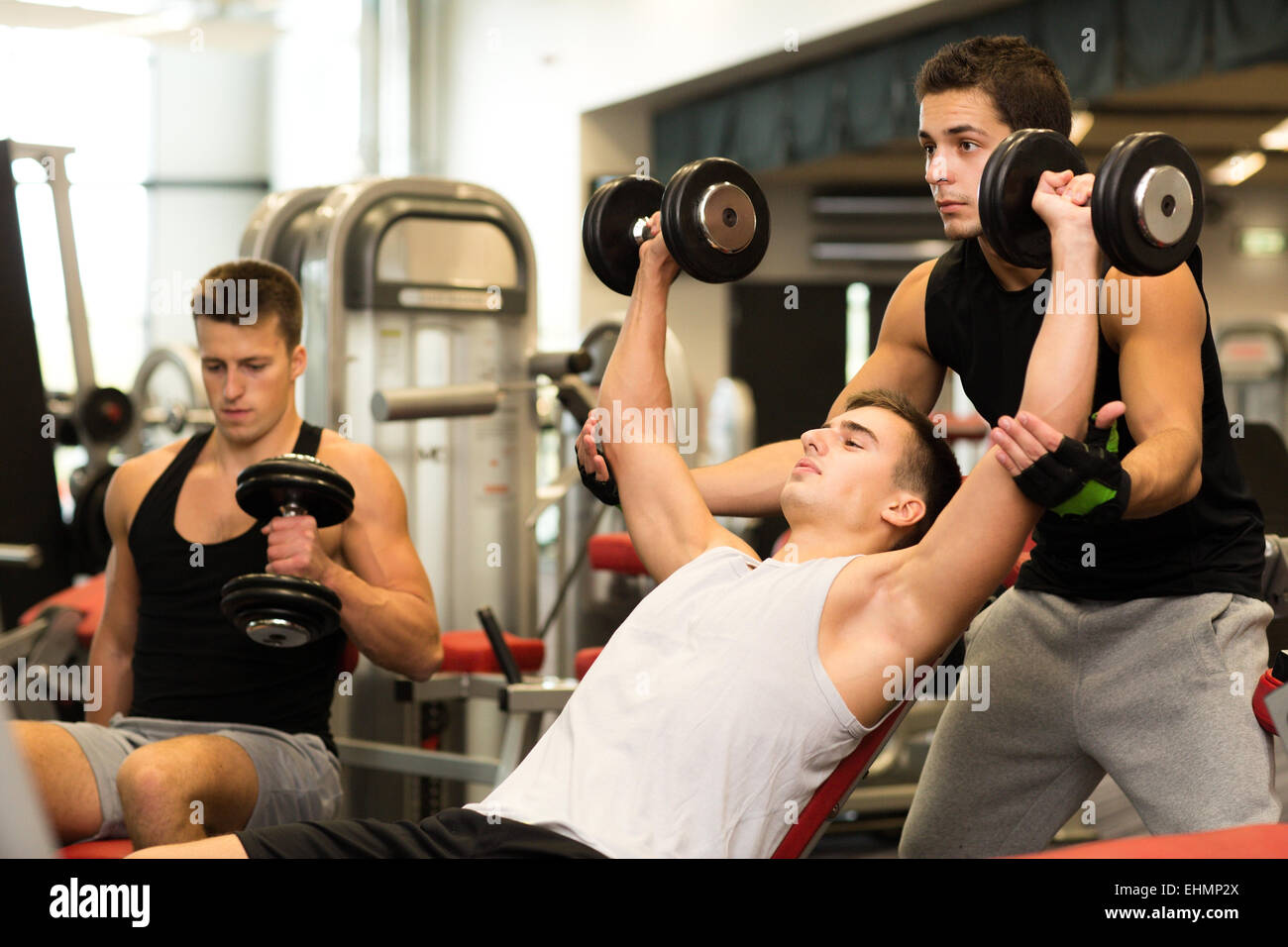 group of men with dumbbells in gym Stock Photo - Alamy