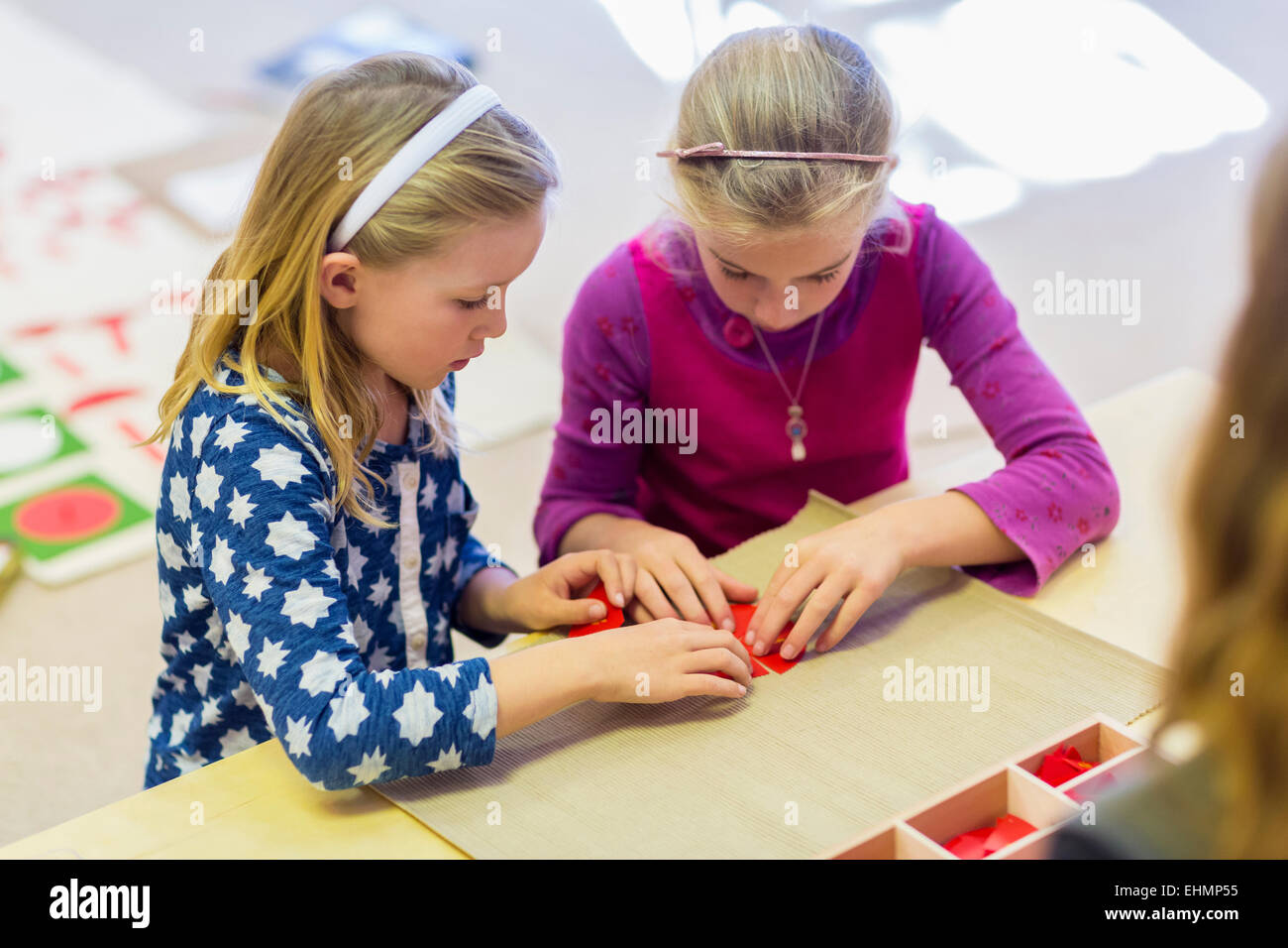 Caucasian girls working together in classroom Stock Photo - Alamy