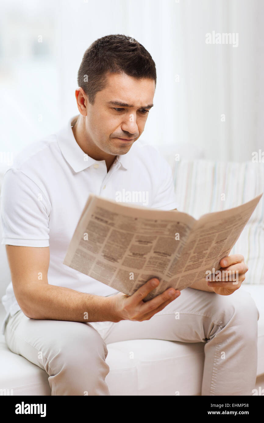 sad man reading newspaper at home Stock Photo - Alamy