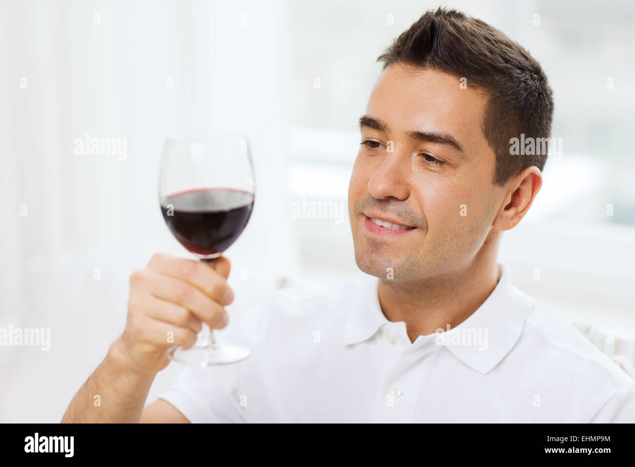 Smiling man drinking glass red hi-res stock photography and images - Alamy