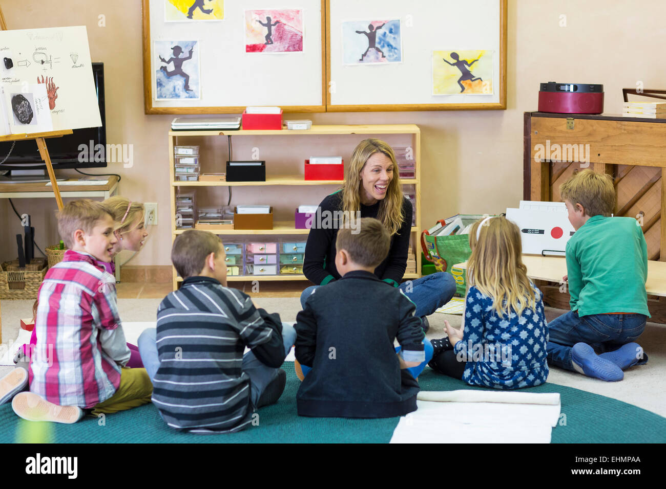Montessori teacher talking to students in classroom Stock Photo - Alamy