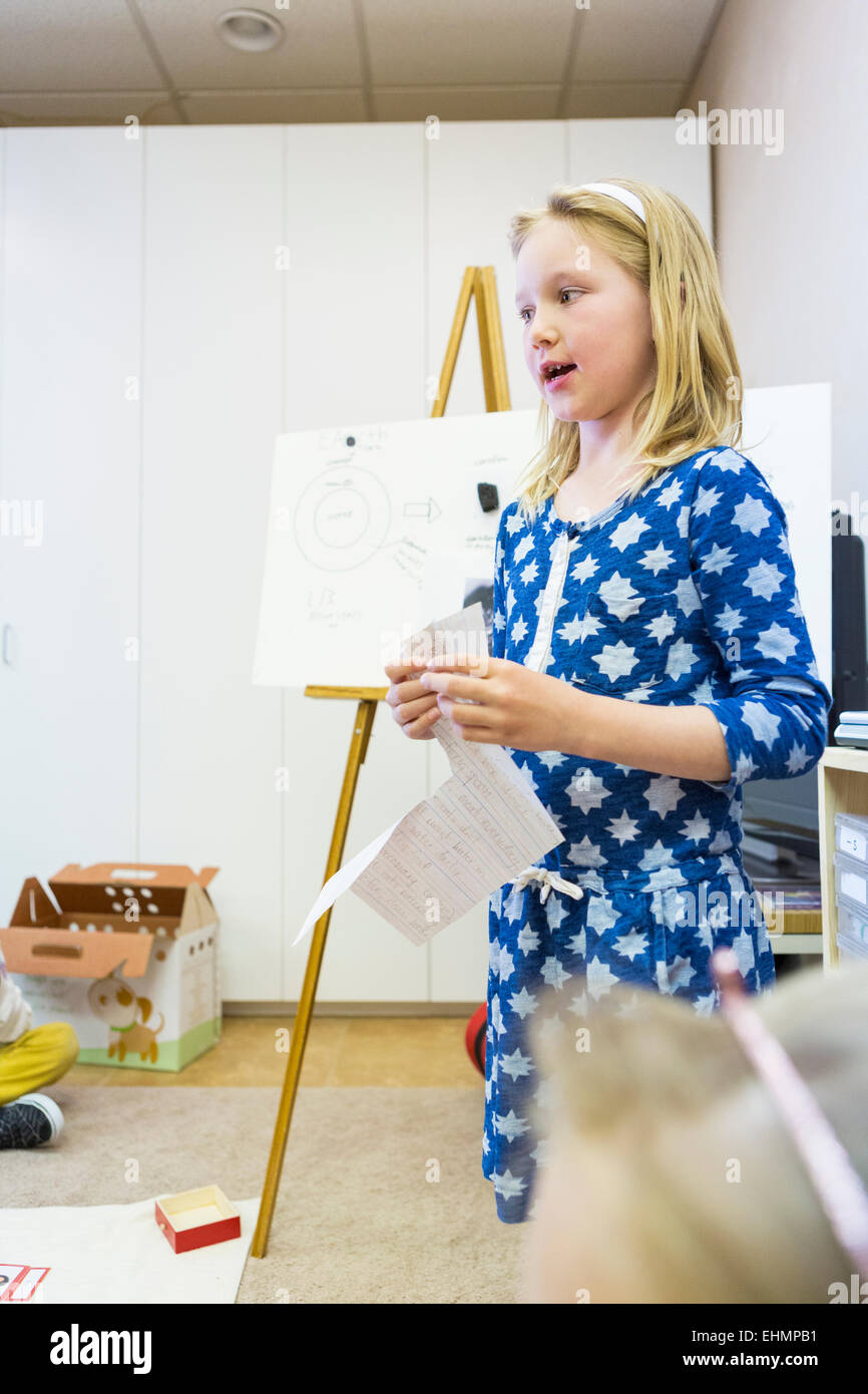 Caucasian girl giving presentation to classmates Stock Photo - Alamy