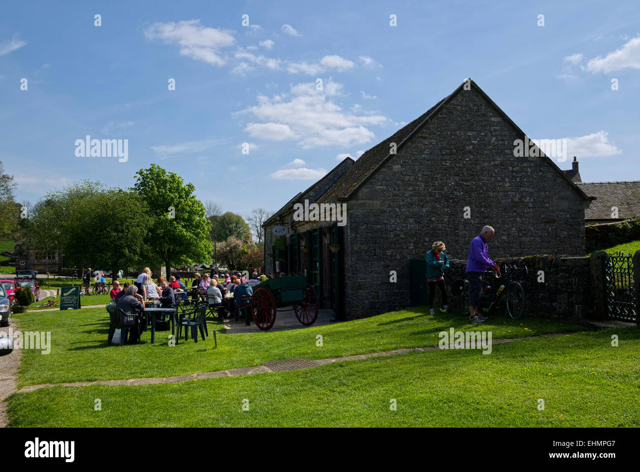 People sitting outside cafe in the Derbyshire village of Tissington ...
