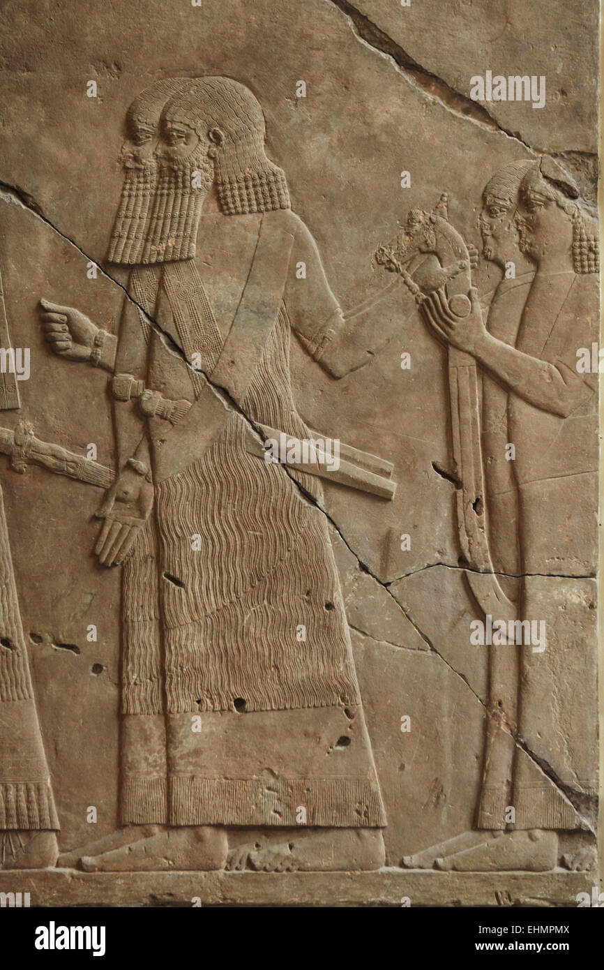 Assyrian officers and courtiers carrying a throne. Palace Relief from ...