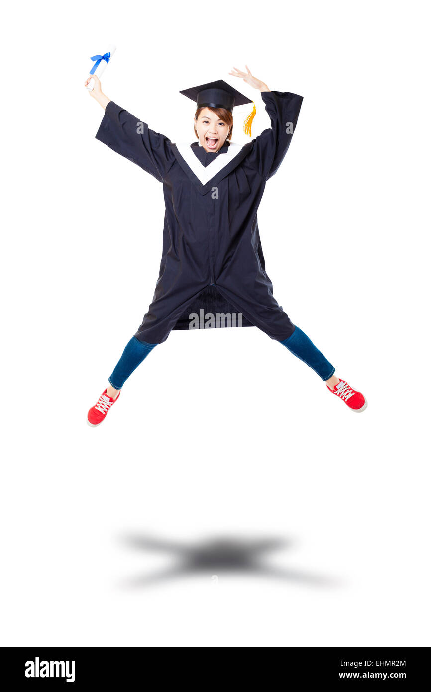 Happy female student in graduate robe jumping against white background ...