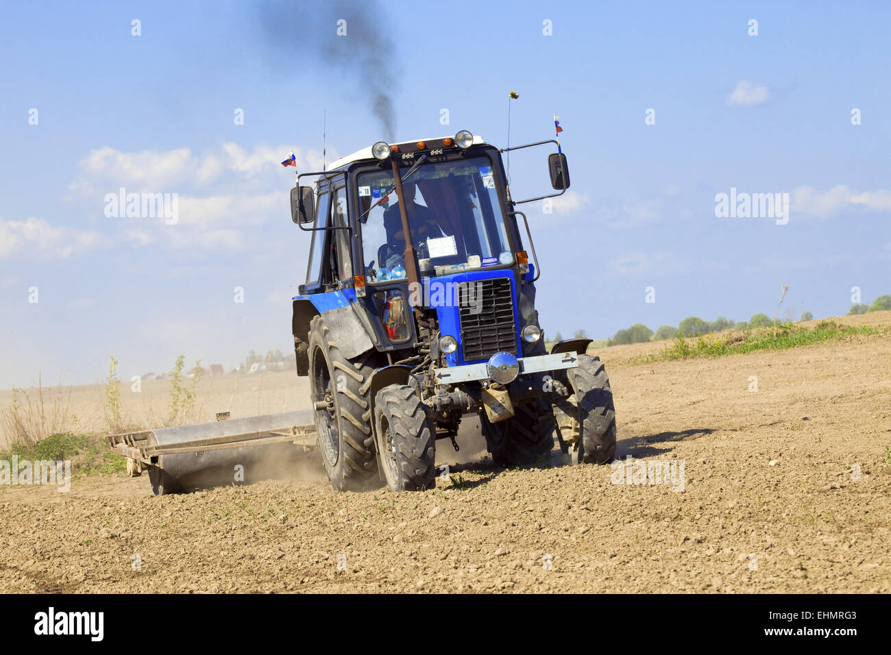 Tractor works in the field Stock Photo - Alamy