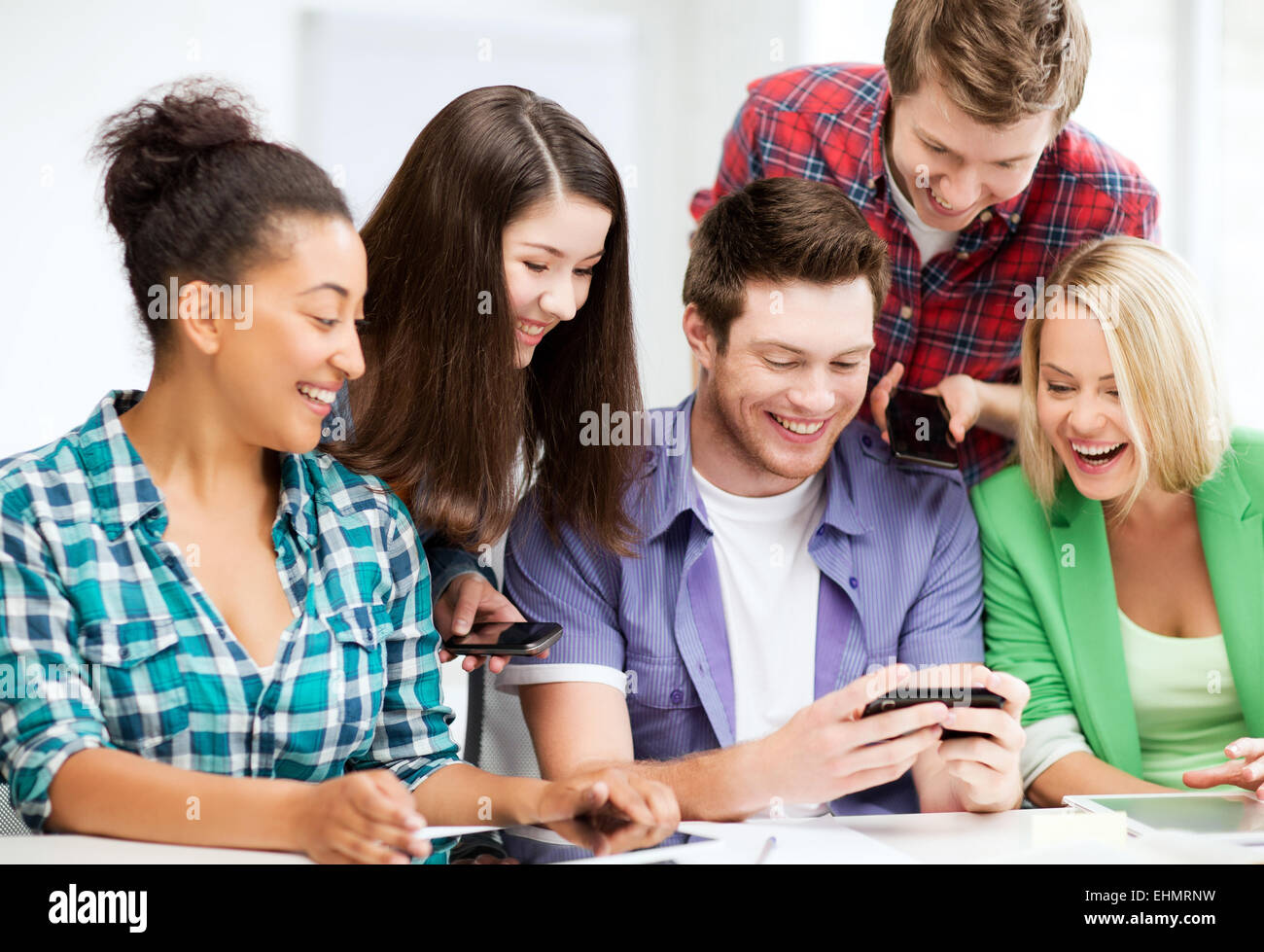 students looking at smartphone at school Stock Photo - Alamy