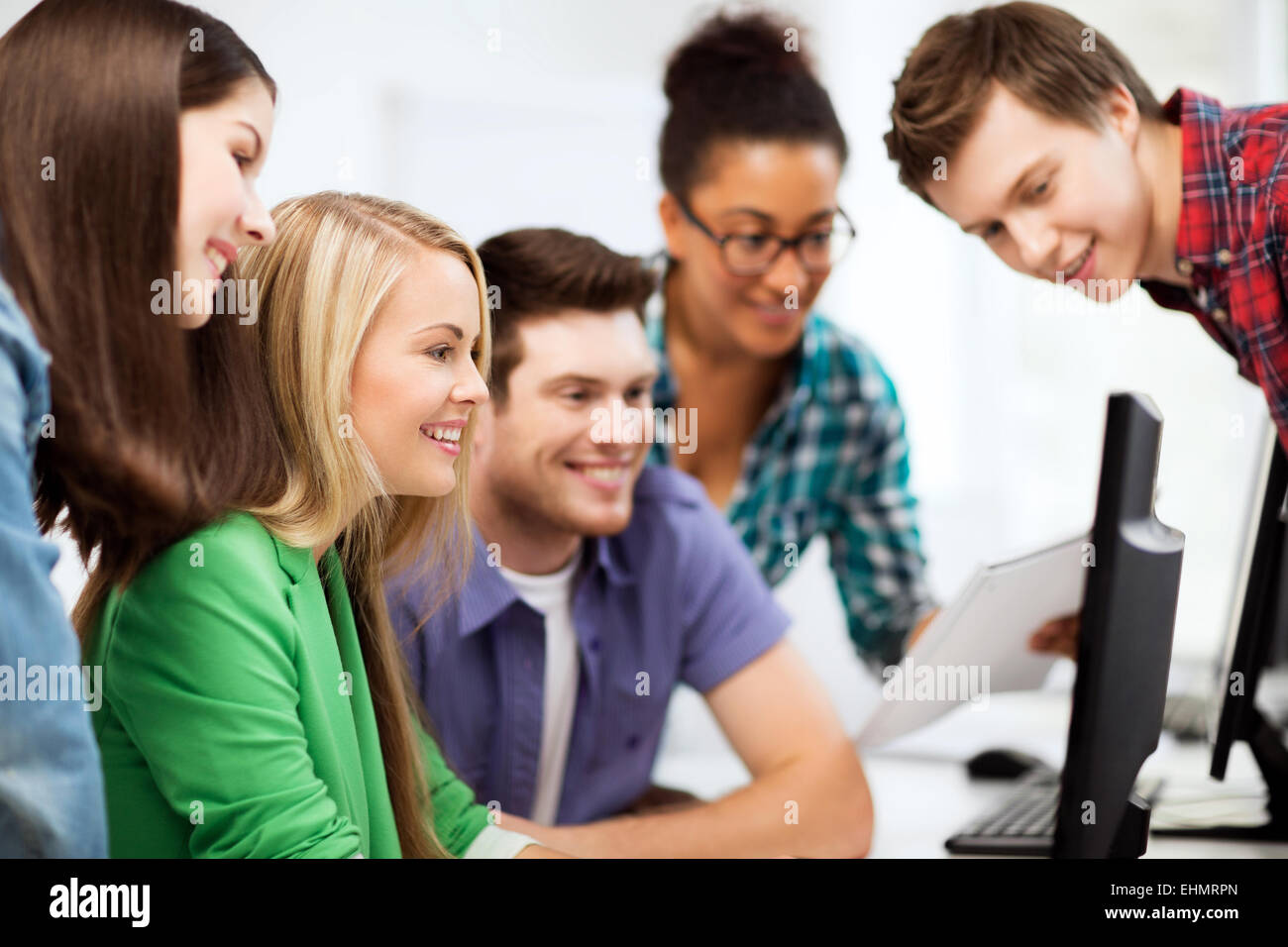 students looking at computer monitor at school Stock Photo - Alamy