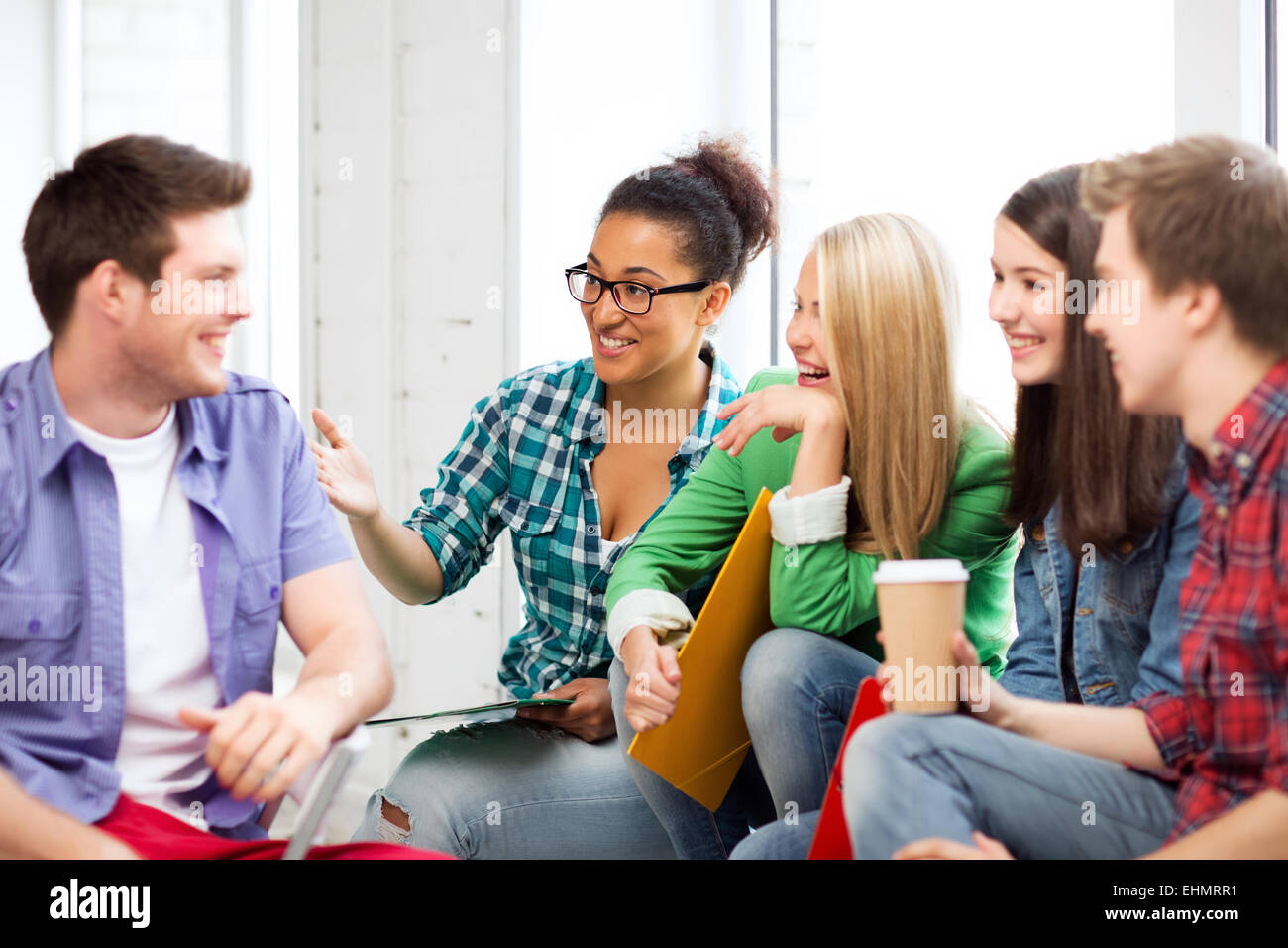 students communicating and laughing at school Stock Photo - Alamy