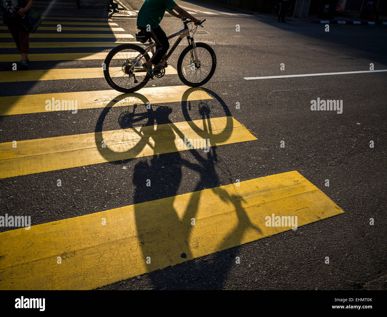 Cycling in the city with shadows from the morning sun Stock Photo - Alamy