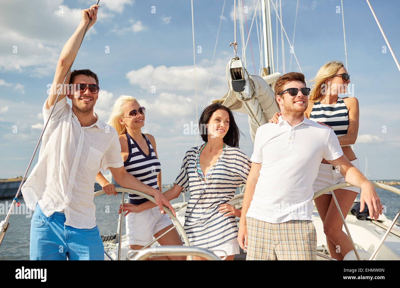 smiling friends sailing on yacht Stock Photo - Alamy