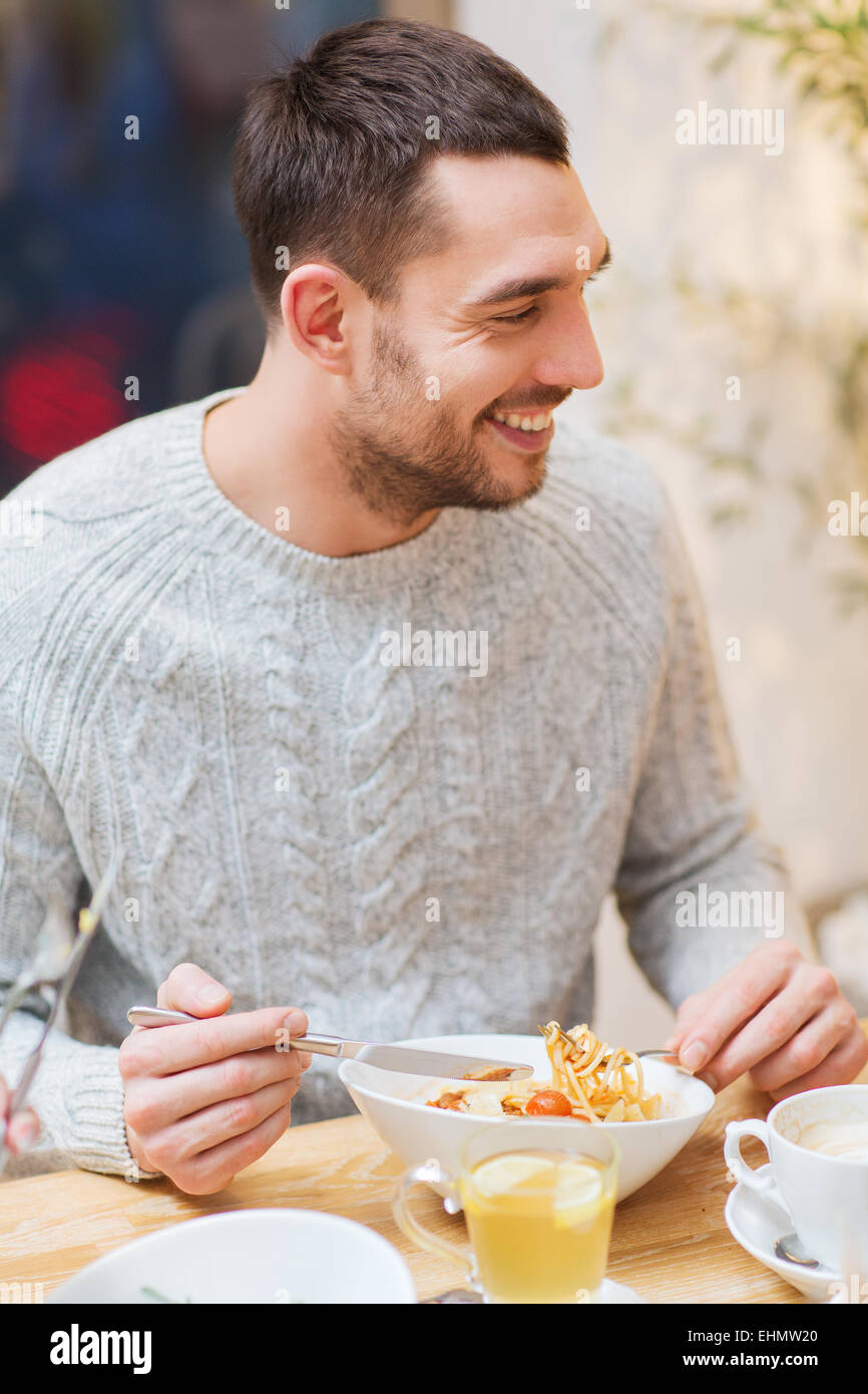 happy young man having dinner at restaurant Stock Photo - Alamy