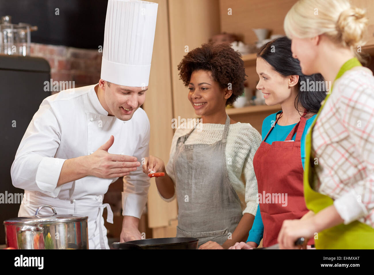 happy women and chef cook cooking in kitchen Stock Photo - Alamy
