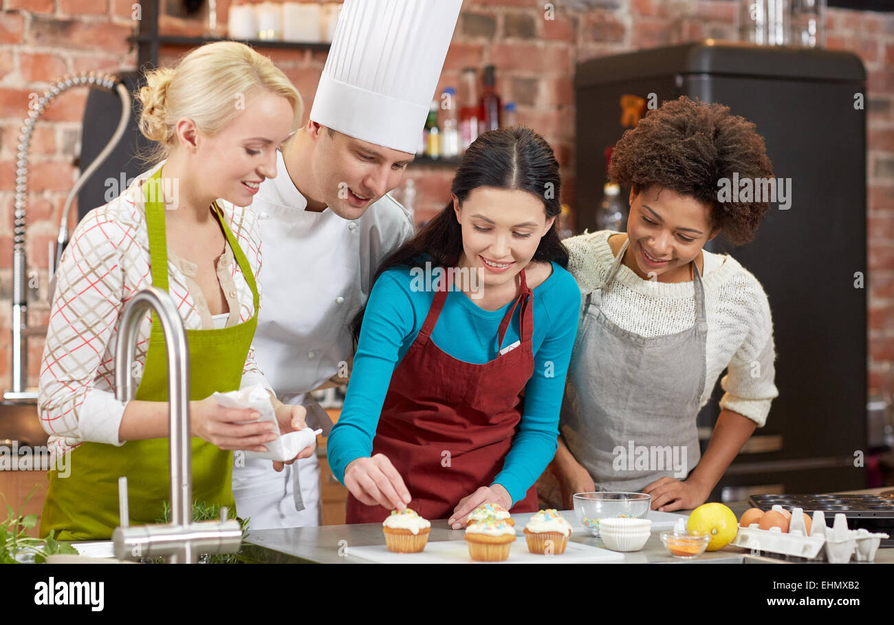 happy women and chef cook cooking in kitchen Stock Photo - Alamy