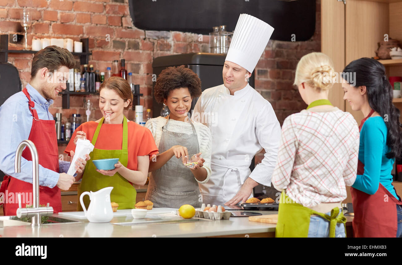 happy friends and chef cook cooking in kitchen Stock Photo - Alamy