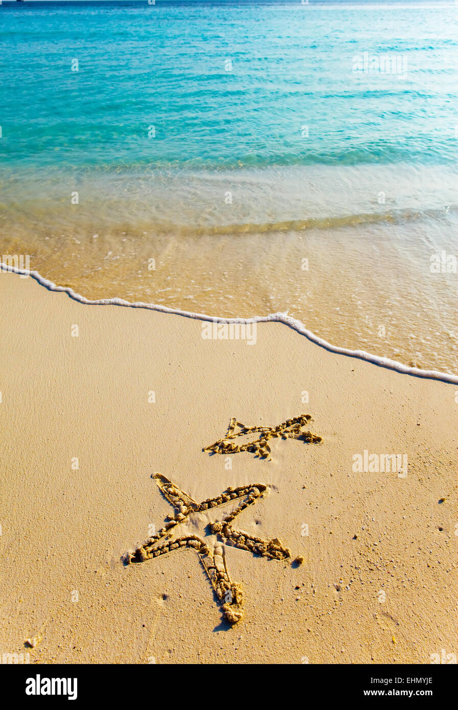 Drawing on sand on a theme of rest Stock Photo - Alamy