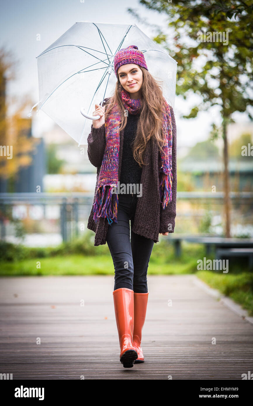 A woman standing under an umbrella hi-res stock photography and images ...