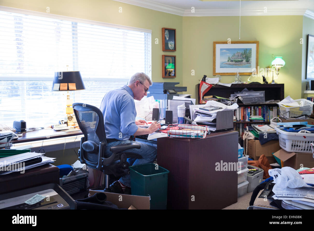 Businessman in Hoarders' Messy Home Office, USA Stock Photo - Alamy