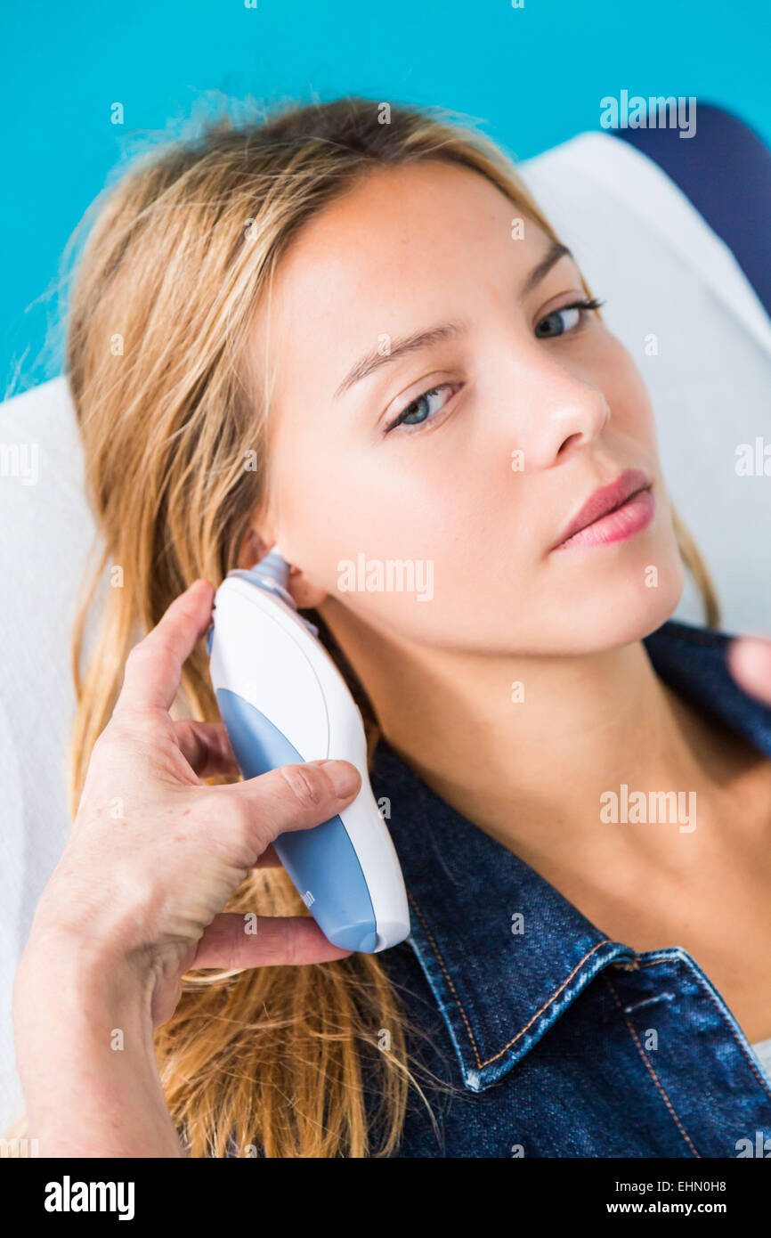 Checking the temperature of a patient with tympanic thermometer Stock ...