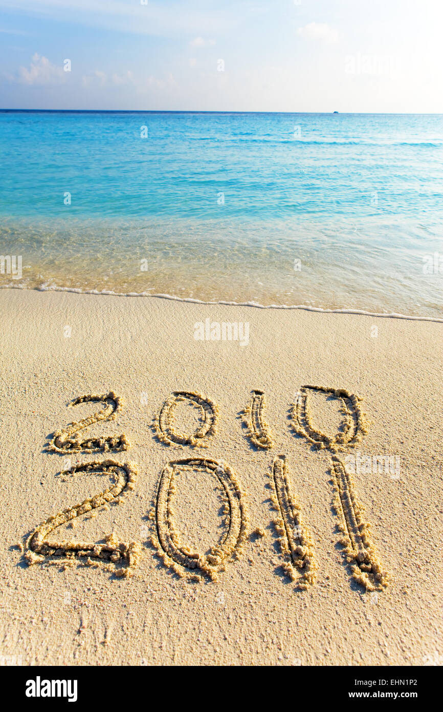 On sand at ocean edge it is written 2011 Stock Photo - Alamy