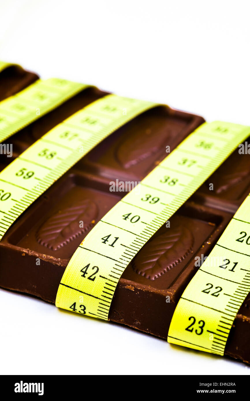 A composition of chocolate bars embodied in a tape measure Stock Photo ...