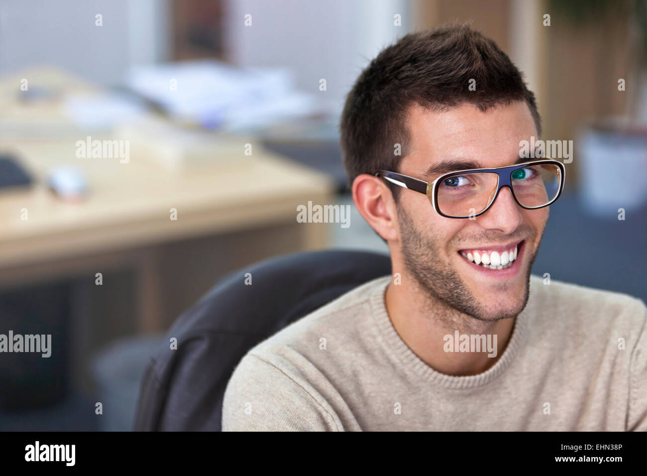 Portrait of a smart an handsome young man in office with available ...