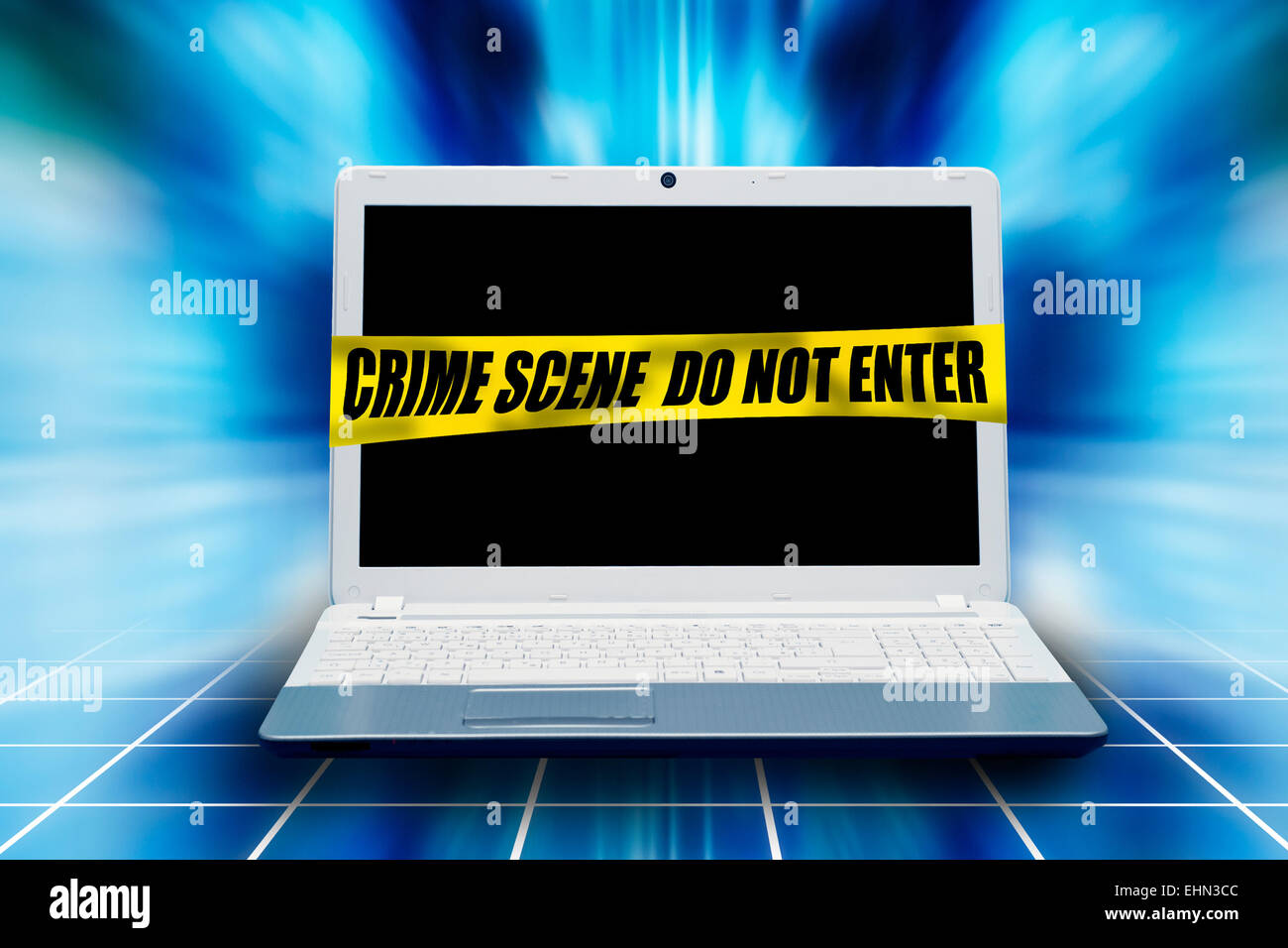 laptop computer with crime scene do not enter yellow tape over it Stock ...