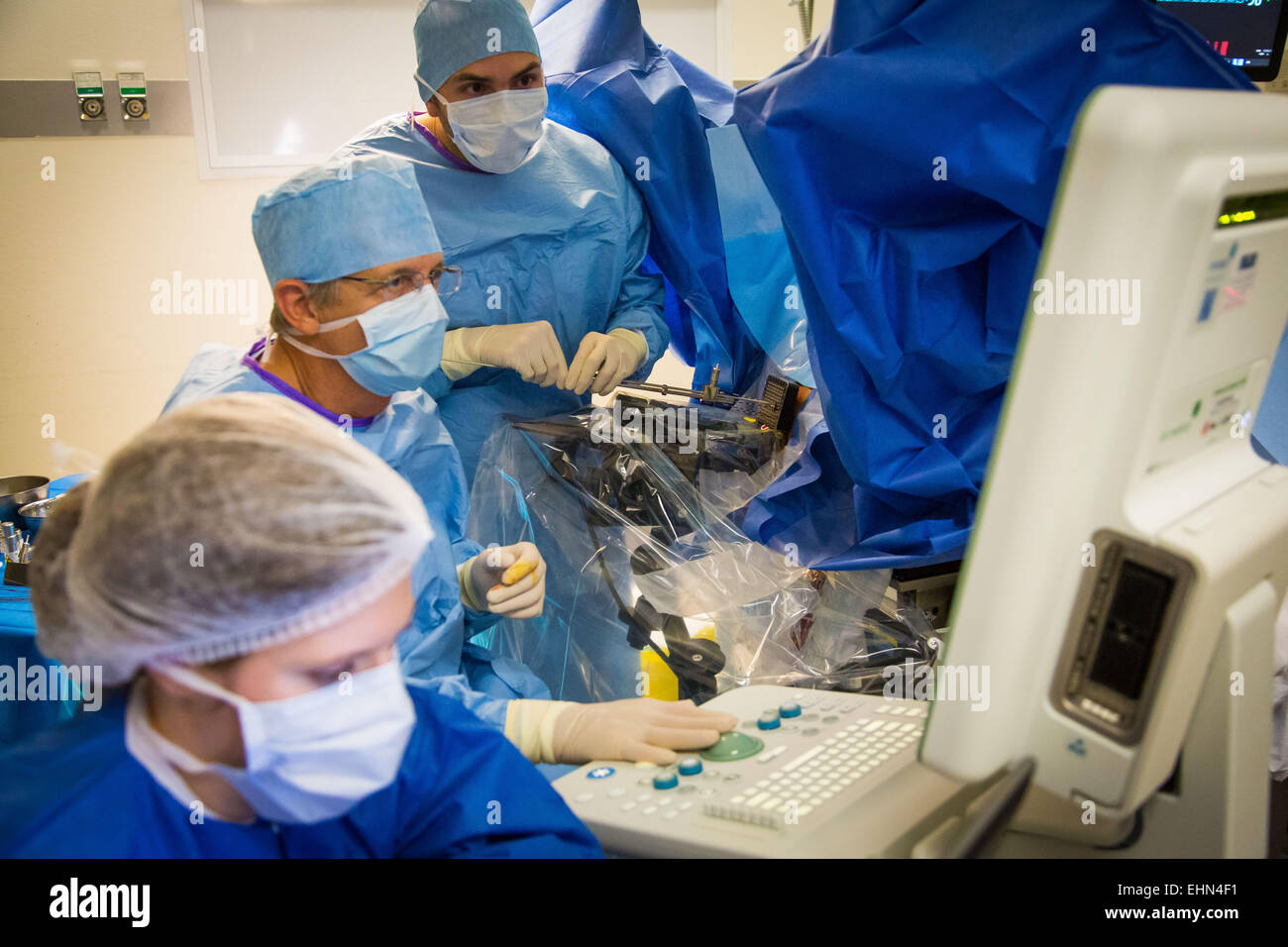 Prostate cancer radiotherapy surgery. Radiologist inserting a hollow ...