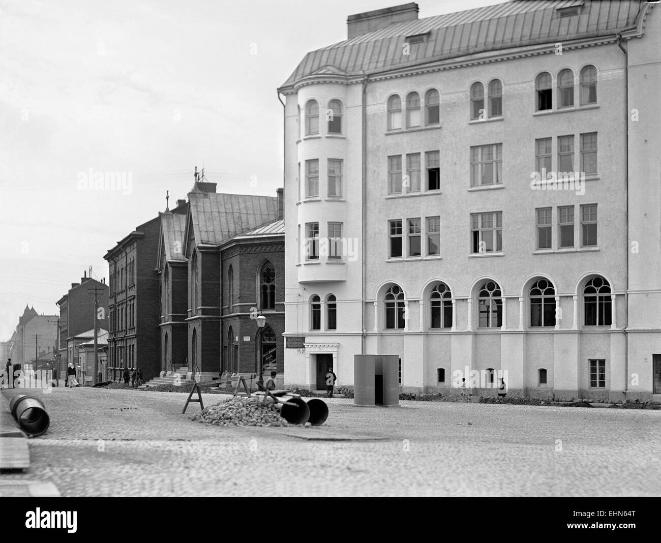 This early 20th-century photograph by I.K. Inha captures a street scene ...