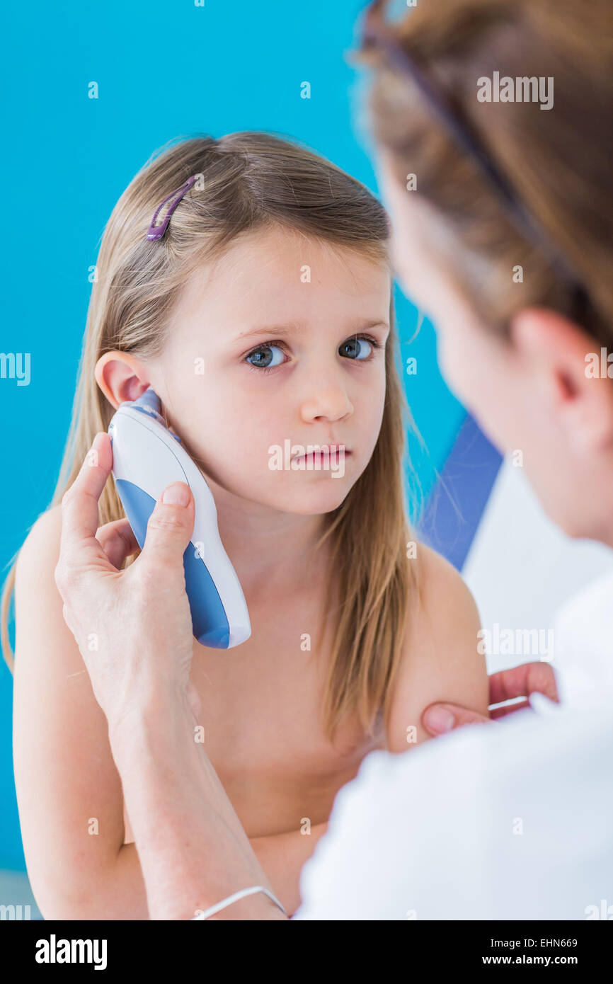 Doctor checking the temperature of a 4 year old baby with a digital ...