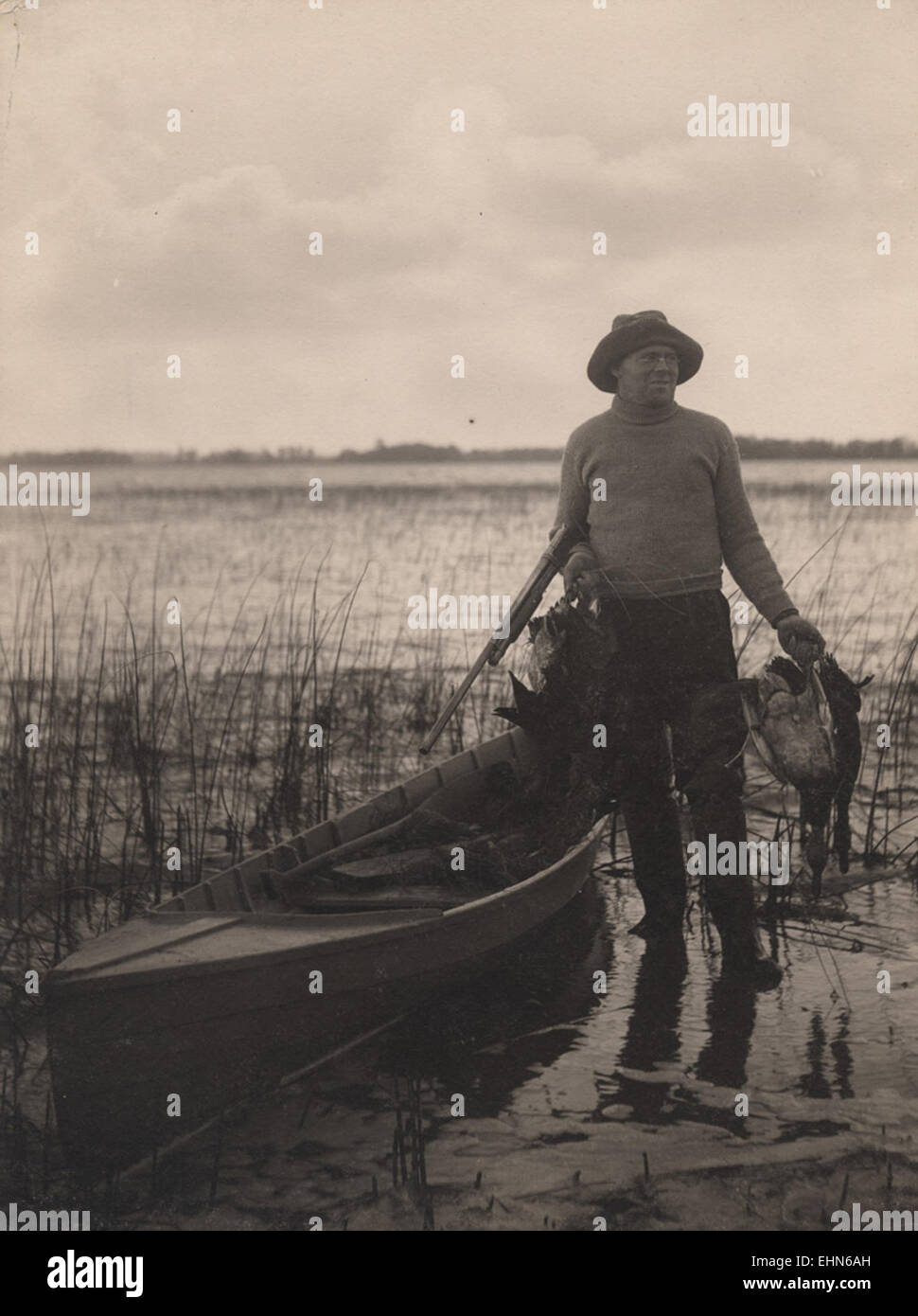 This 1909 photograph captures a duck hunting scene involving canoes ...