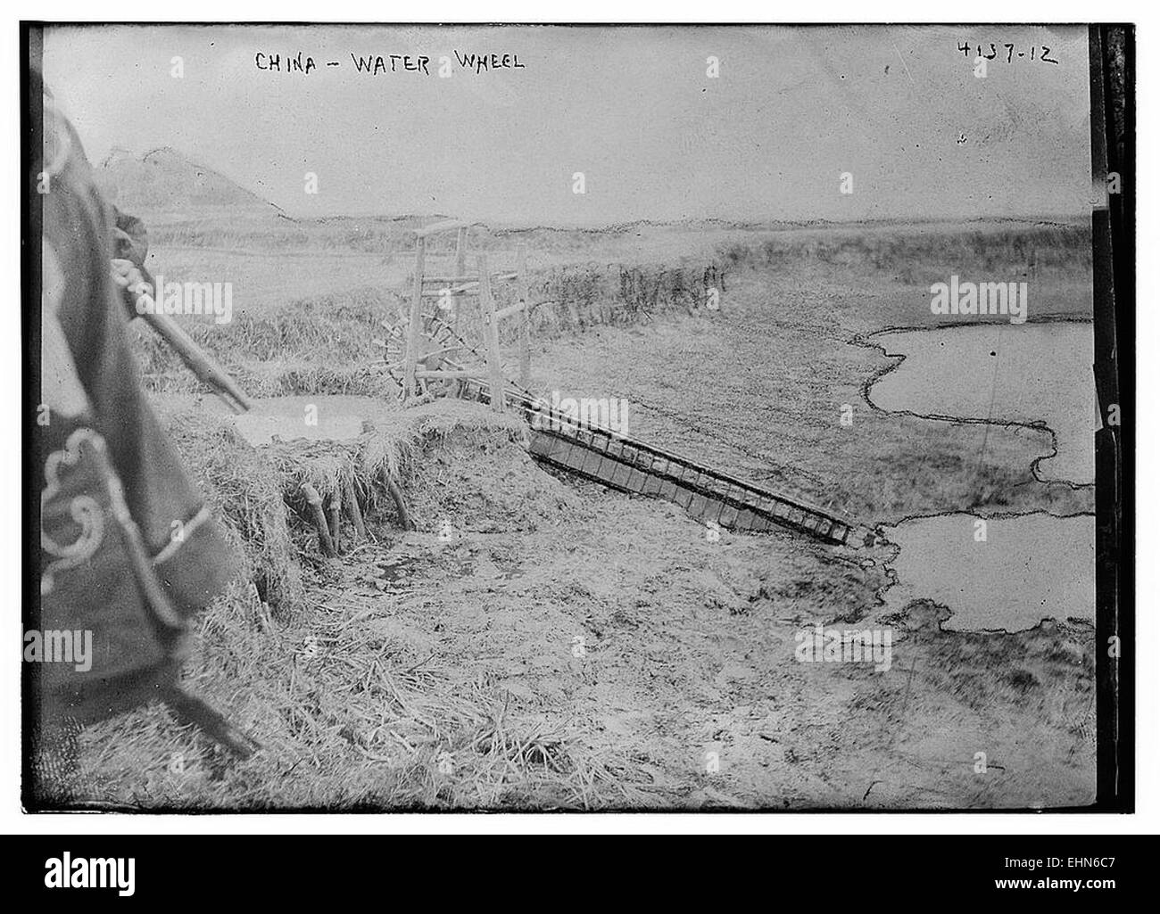 The depiction of a water wheel in China showcases a traditional method ...