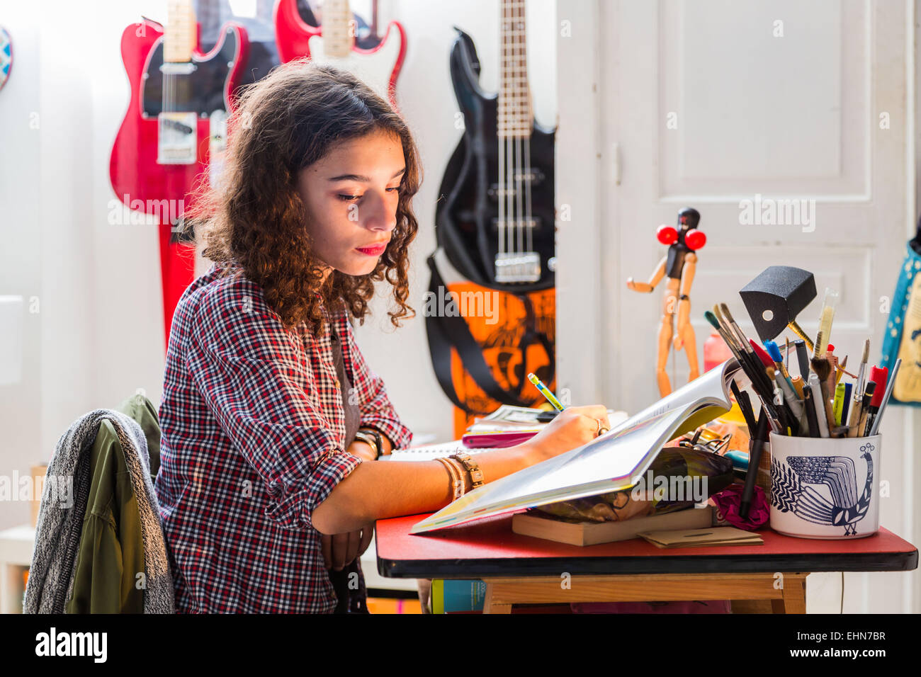 Teenage girl doing homework Stock Photo - Alamy