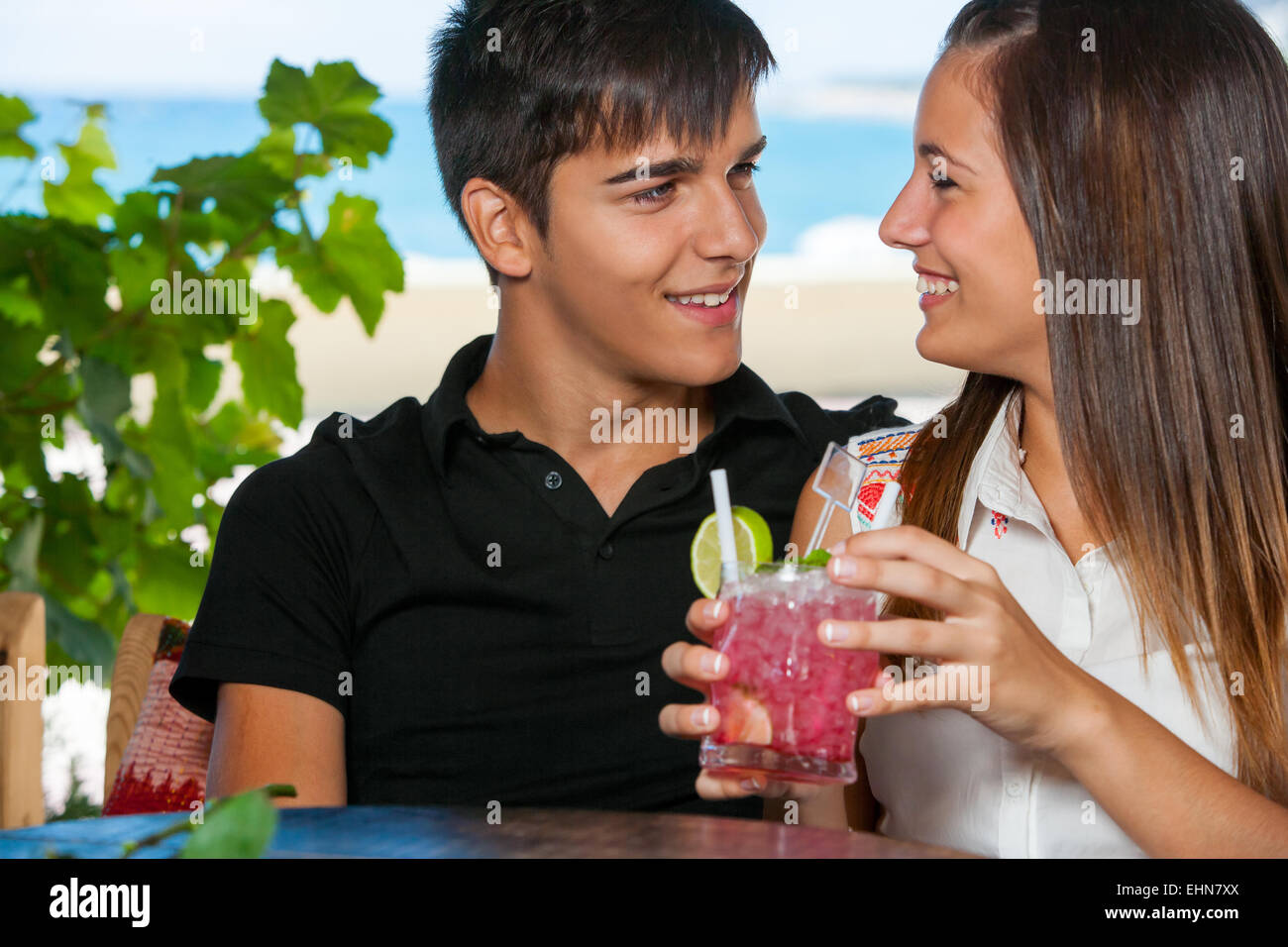 Close up portrait of young couple sharing cocktail on date Stock Photo ...
