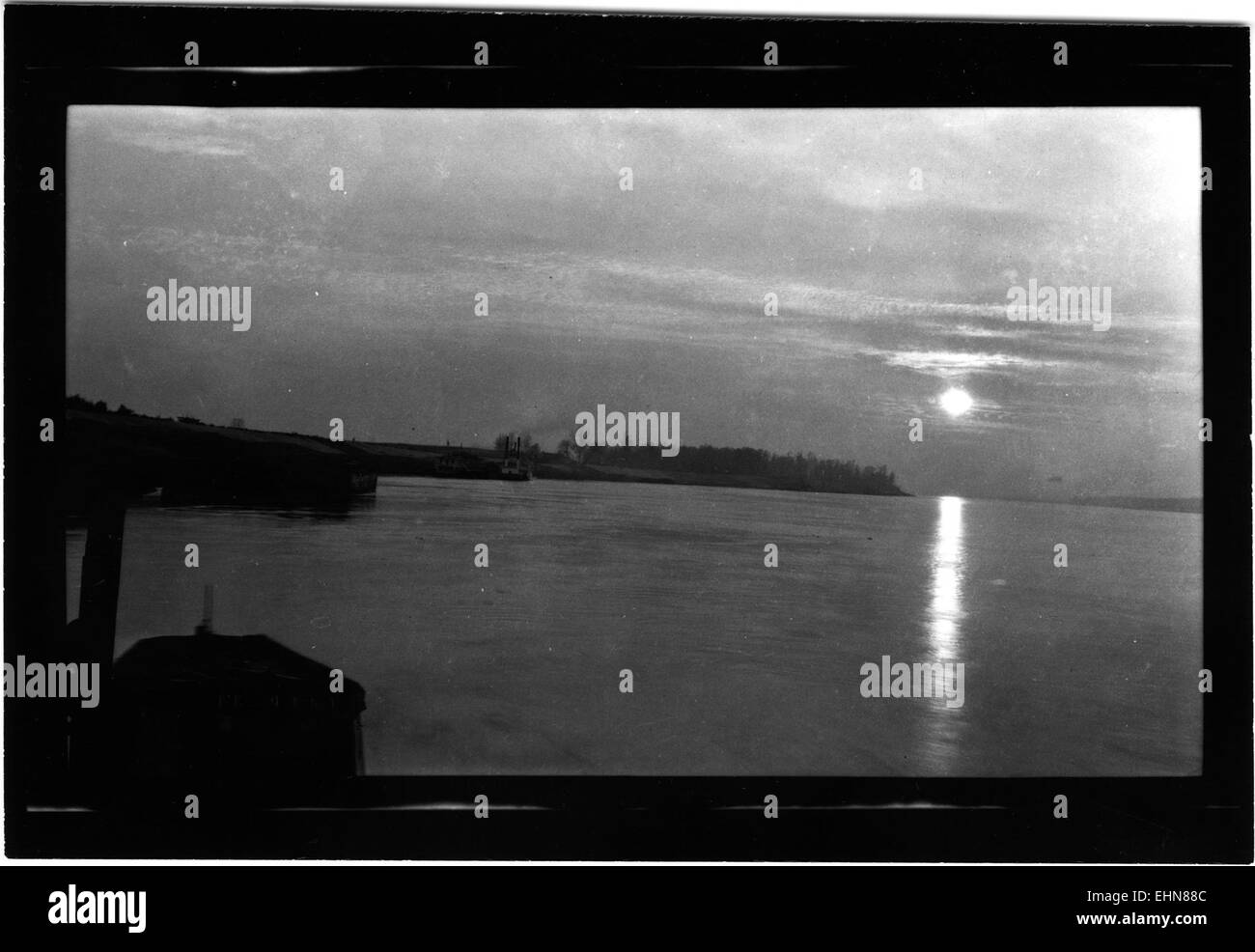 This artwork captures a vibrant sunset over the Mississippi River ...