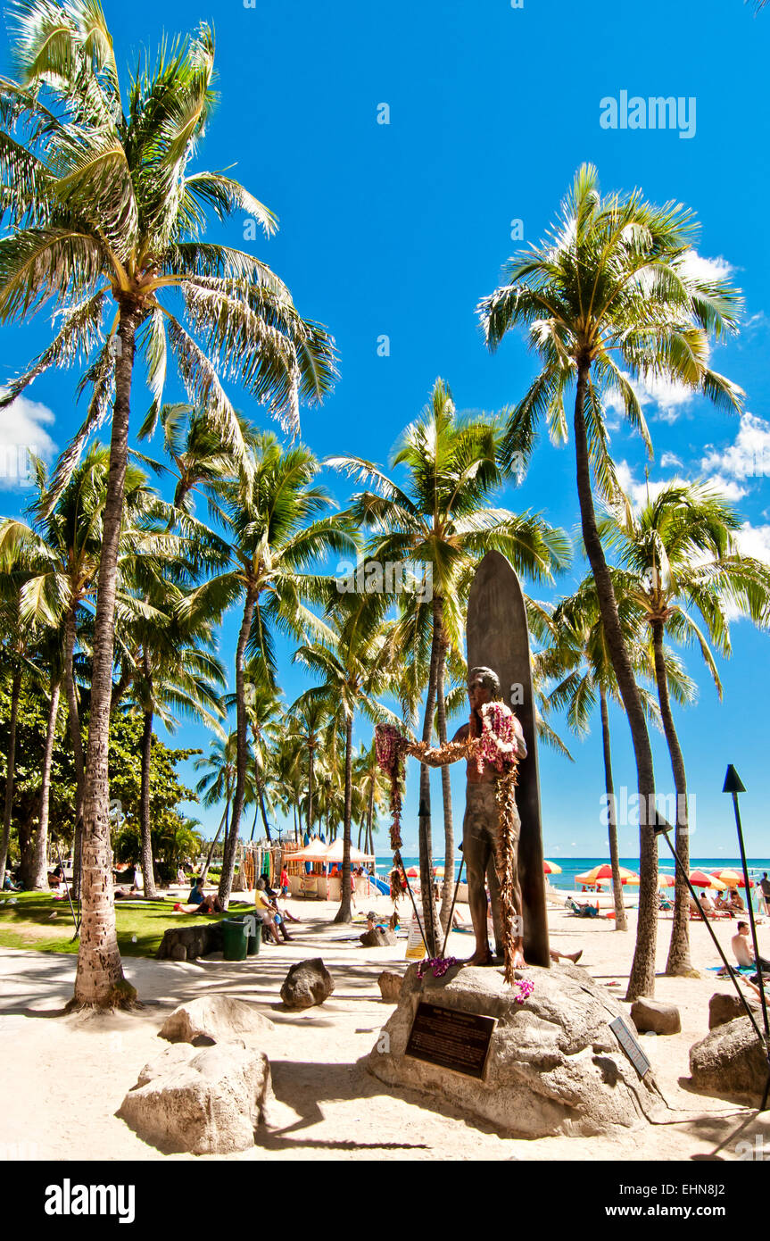 WAIKIKI, HAWAII - SEPTEMBER 7, 2013 Tourists sunbathing and surfing on ...