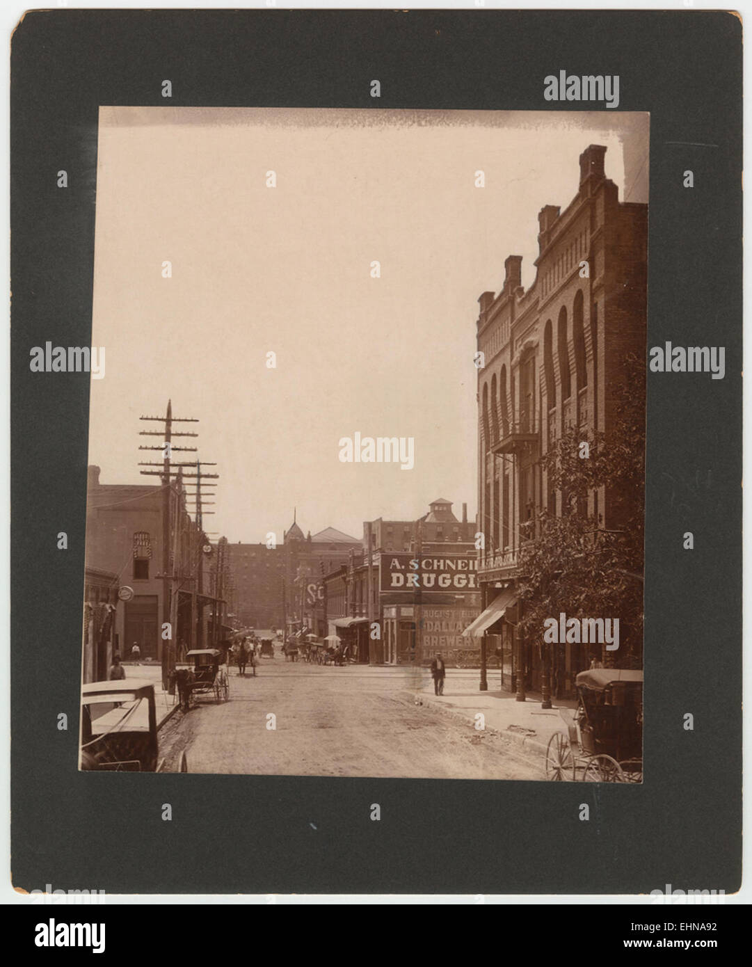 This historical photograph captures Akard Street from the intersection ...