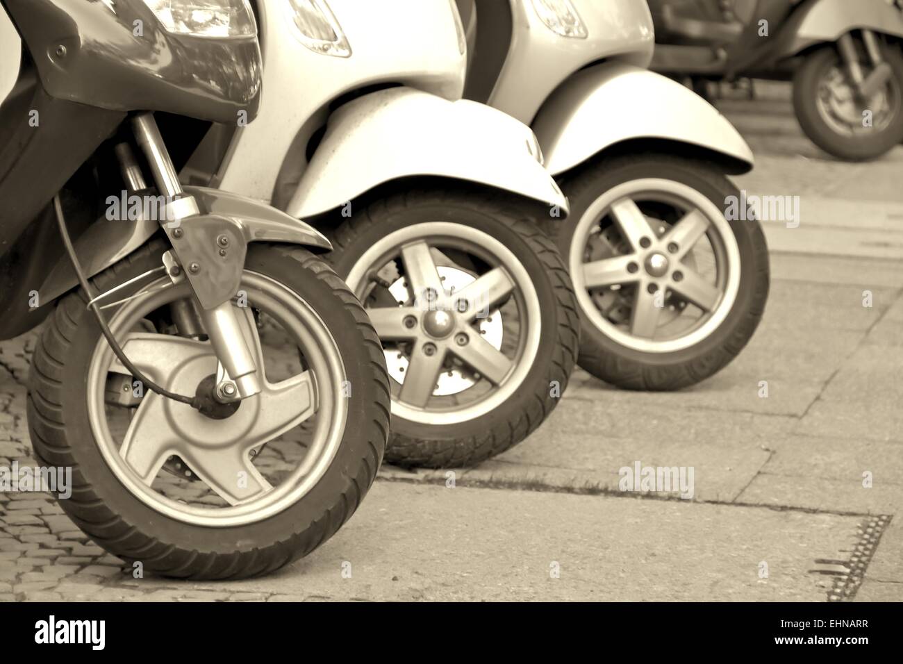 Parked motor scooters on the roadside Stock Photo - Alamy