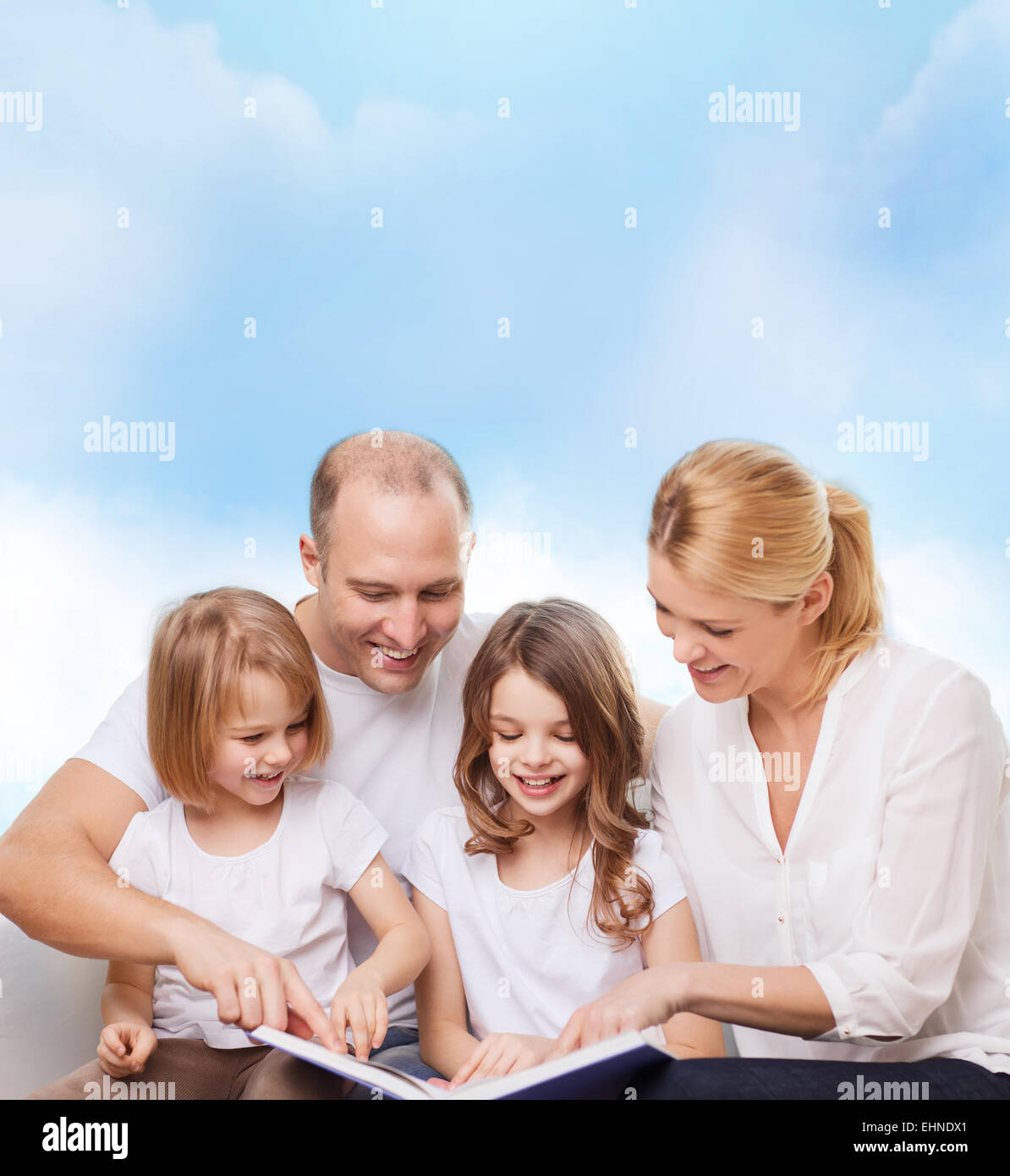 happy family with book at home Stock Photo - Alamy