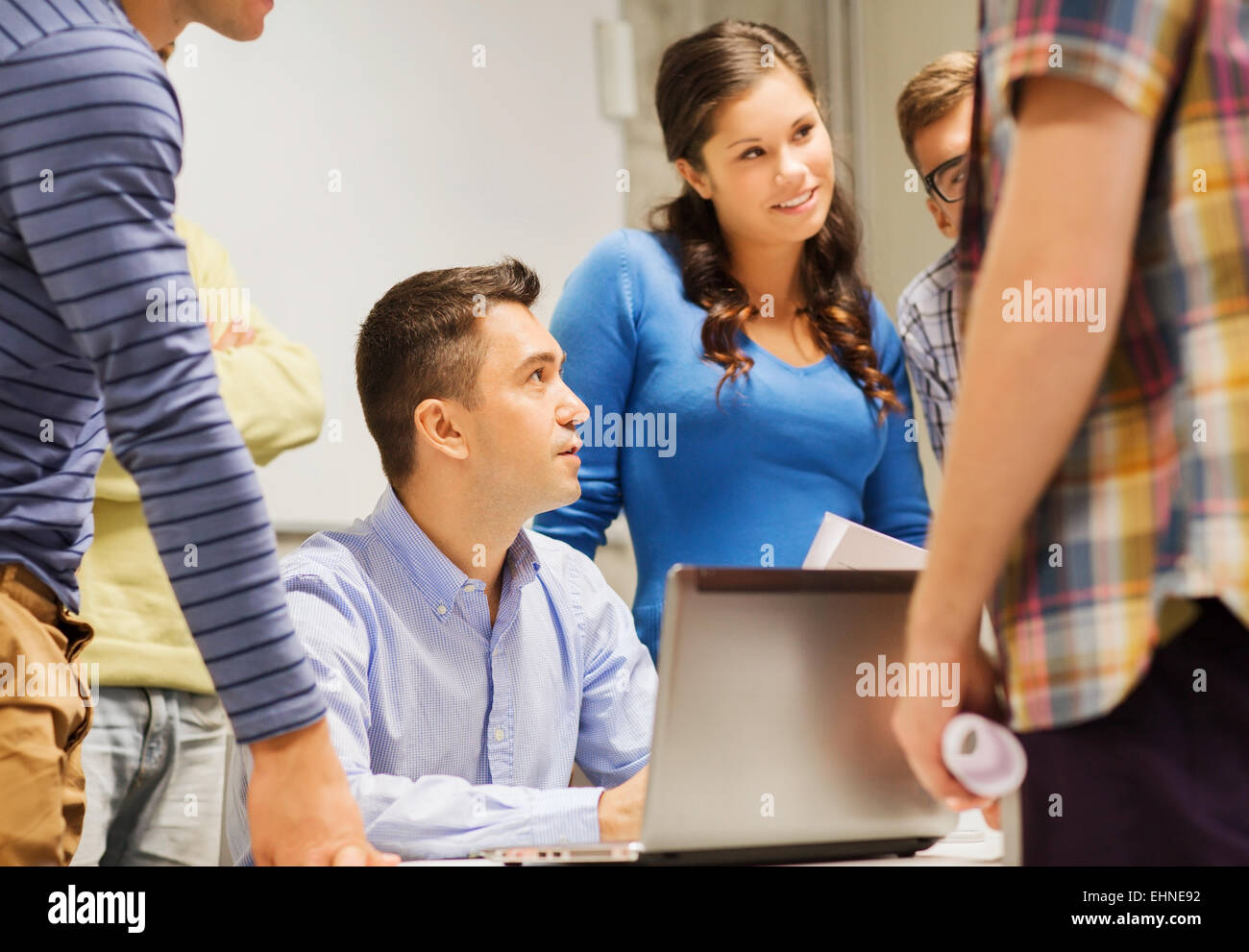 group of students and teacher with laptop Stock Photo - Alamy