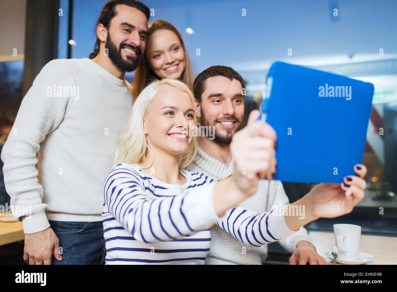 happy friends with tablet pc taking selfie at cafe Stock Photo - Alamy