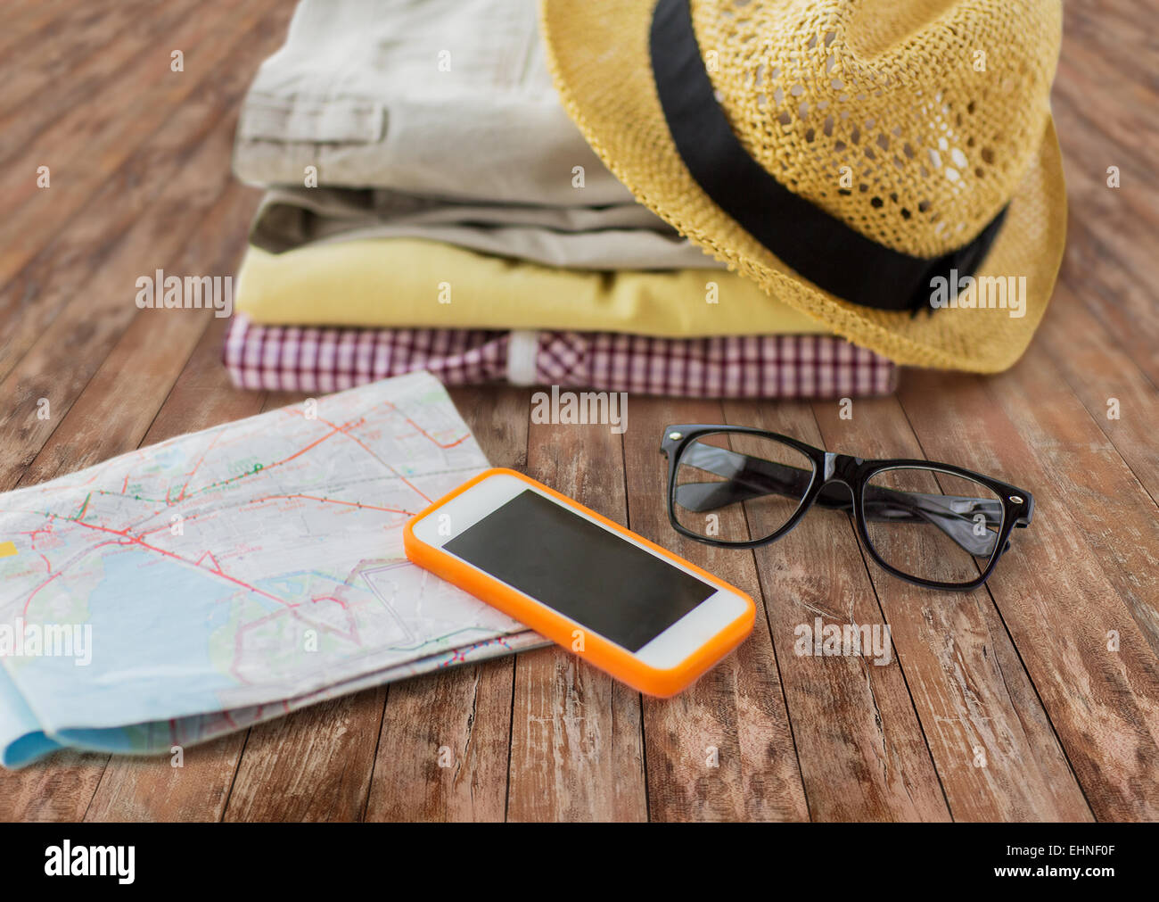 close up of summer clothes and travel map on floor Stock Photo - Alamy