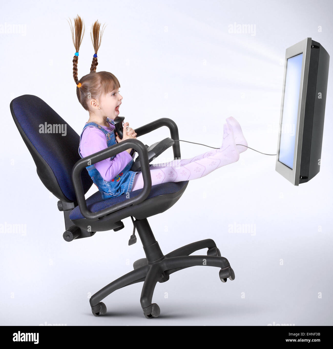 child girl playing computer game with joystick Stock Photo - Alamy