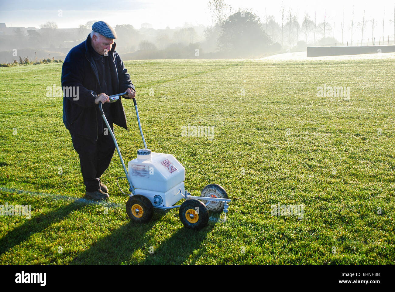 Groundsman at a football pitch painting lines with a linepainter Stock ...