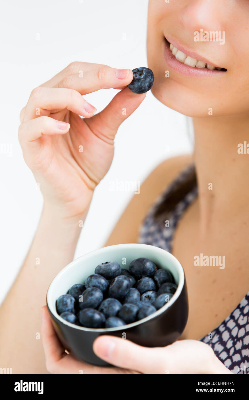 Woman eating blueberries Stock Photo - Alamy