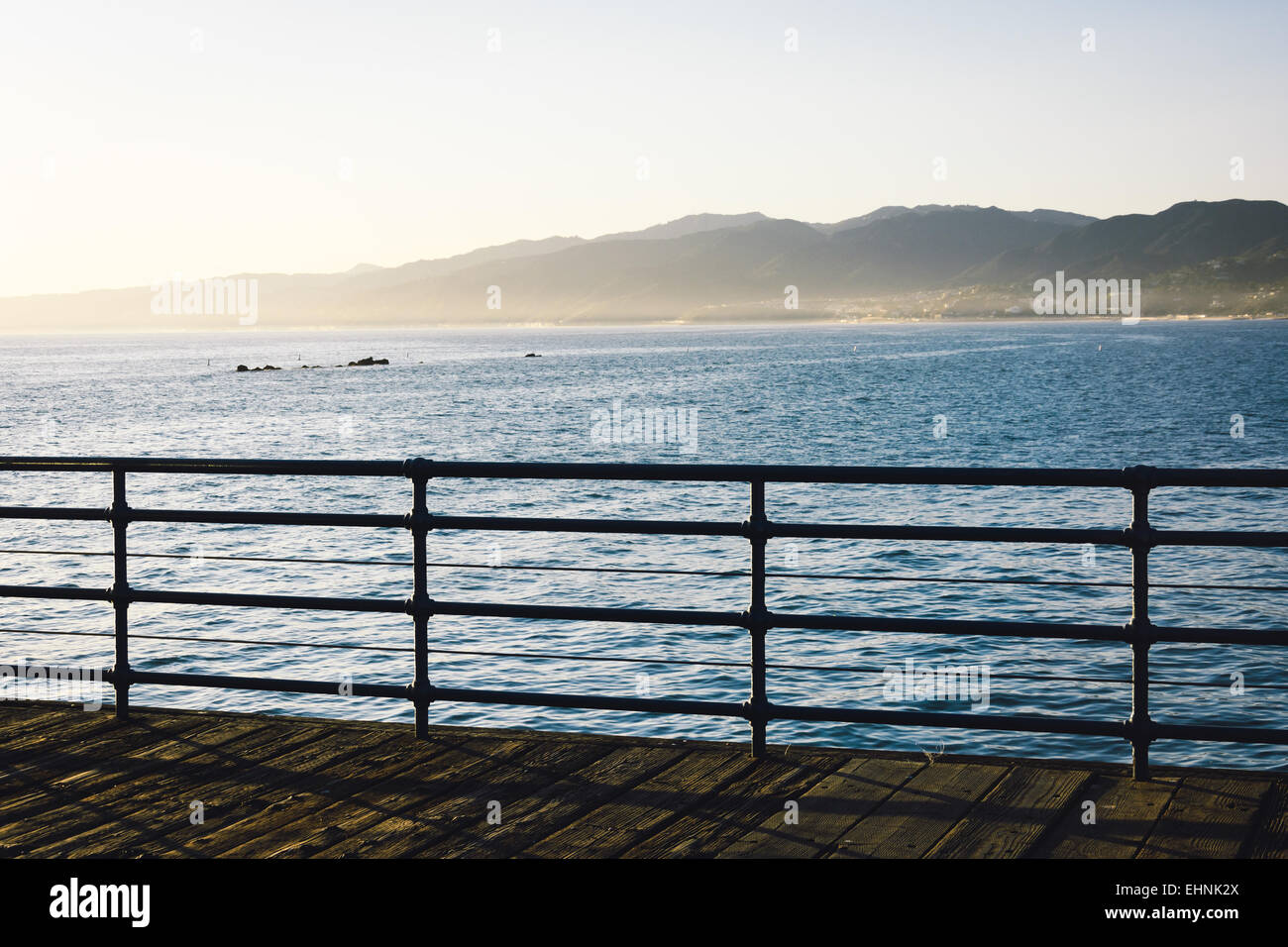 Fence on the Santa Monica Pier and view of mountains and the Pacific ...
