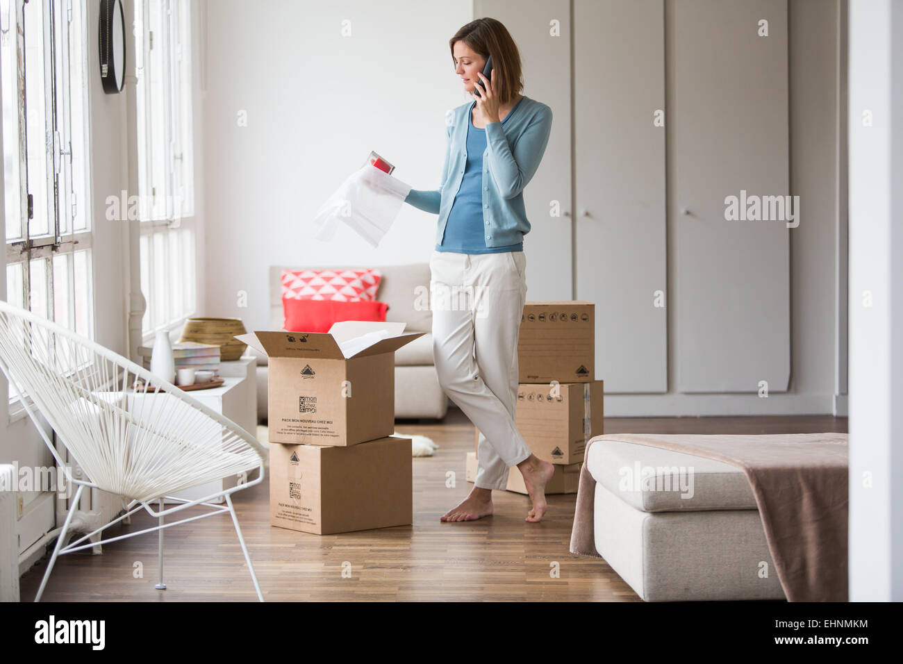 Woman carrying moving boxes in her new home Stock Photo - Alamy